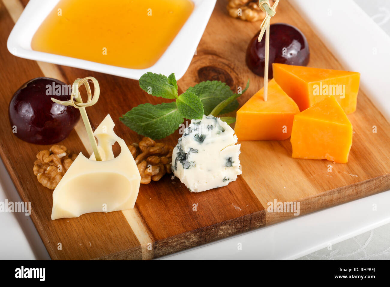 Cheese plate mix with grape, honey and nuts Stock Photo - Alamy