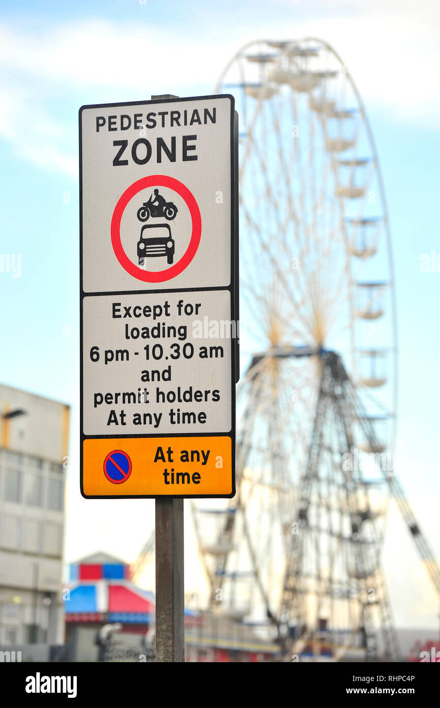 Pedestrian sign with restrictions posted on it in front of the ferris ...