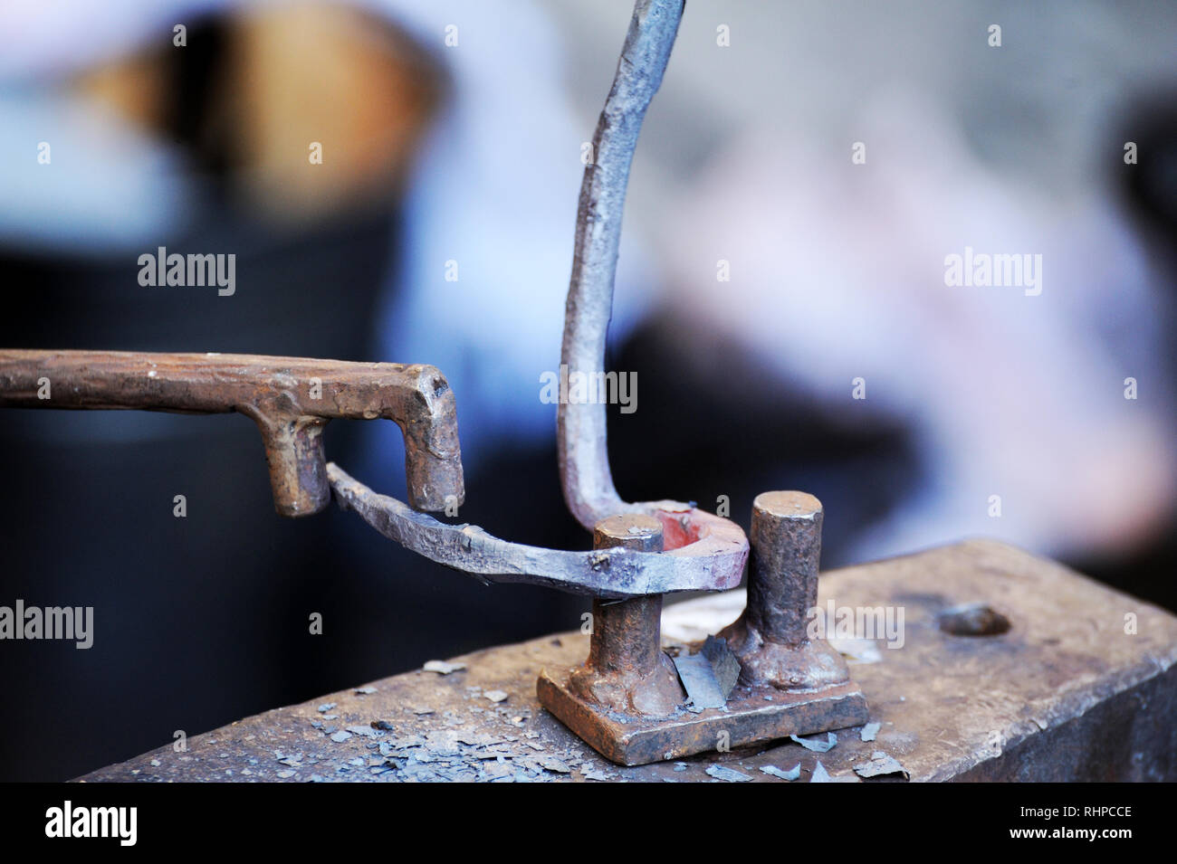 Blacksmith working metal with hammer on the anvil in the forge Stock ...