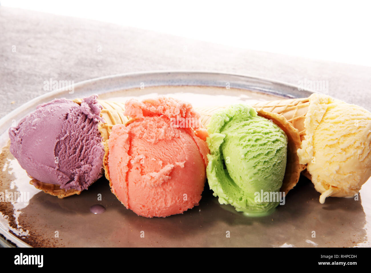 Set of ice cream scoops of different colors and flavours with berries ...