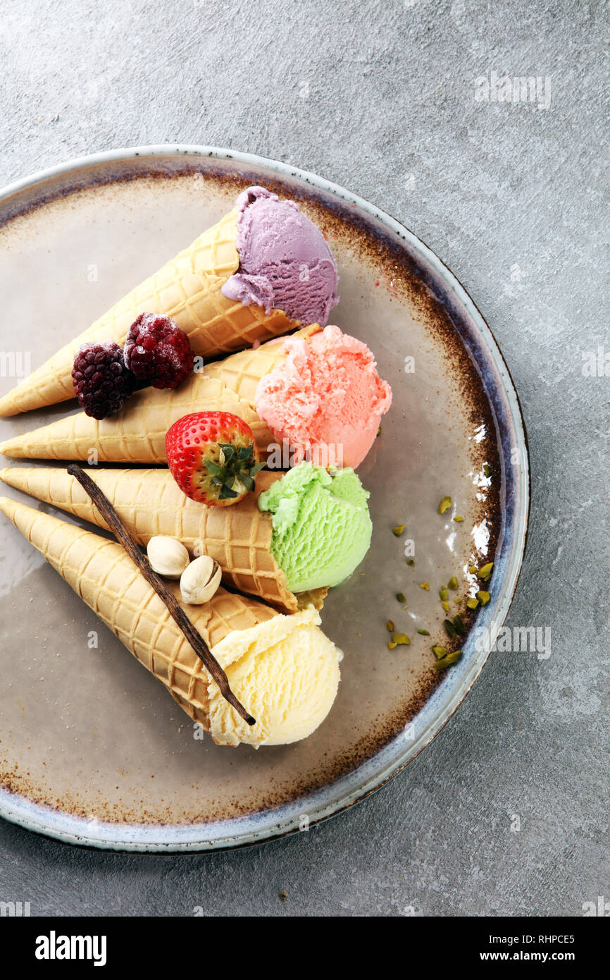 Set of ice cream scoops of different colors and flavours with berries ...