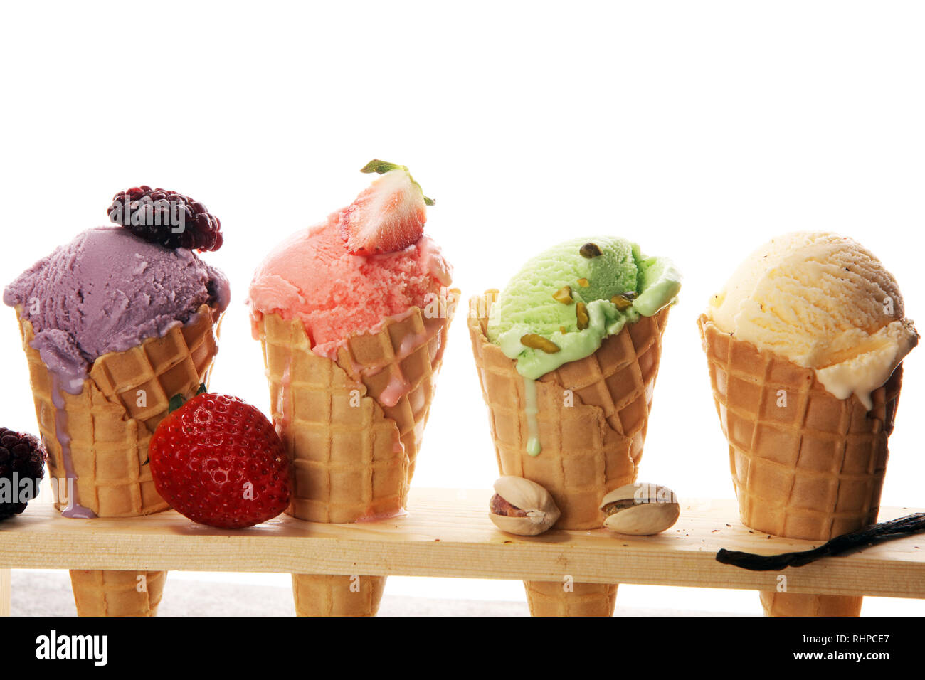 Set of ice cream scoops of different colors and flavours with berries ...