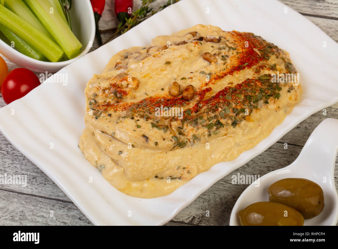 Vegan cuisine - Humus with celery sticks Stock Photo - Alamy