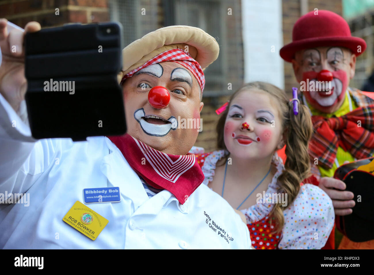 Clowns are seen taking a selfie on a mobile phone during the event ...