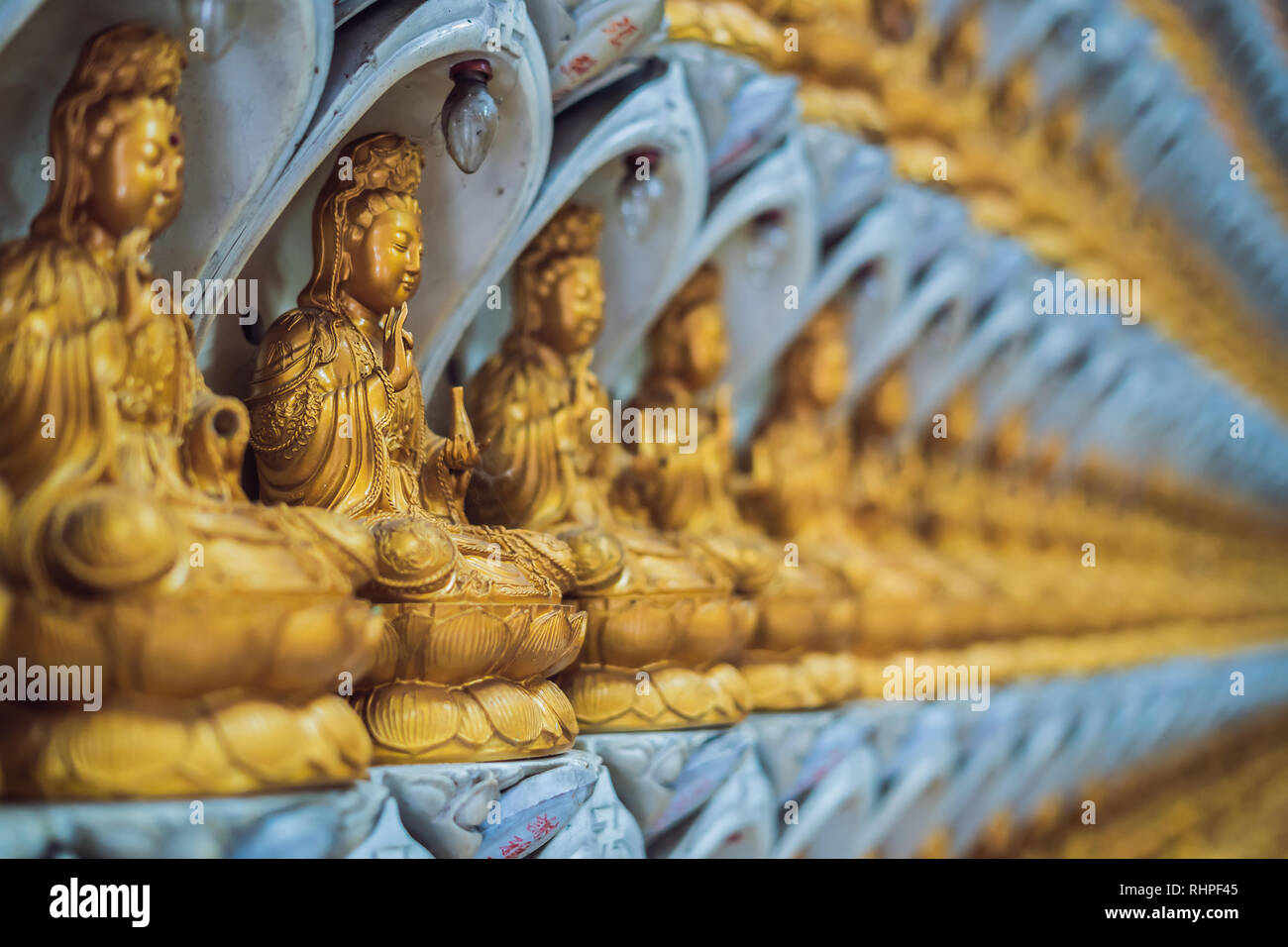 The wall in the temple is filled with buddhas. Religion Buddhism ...