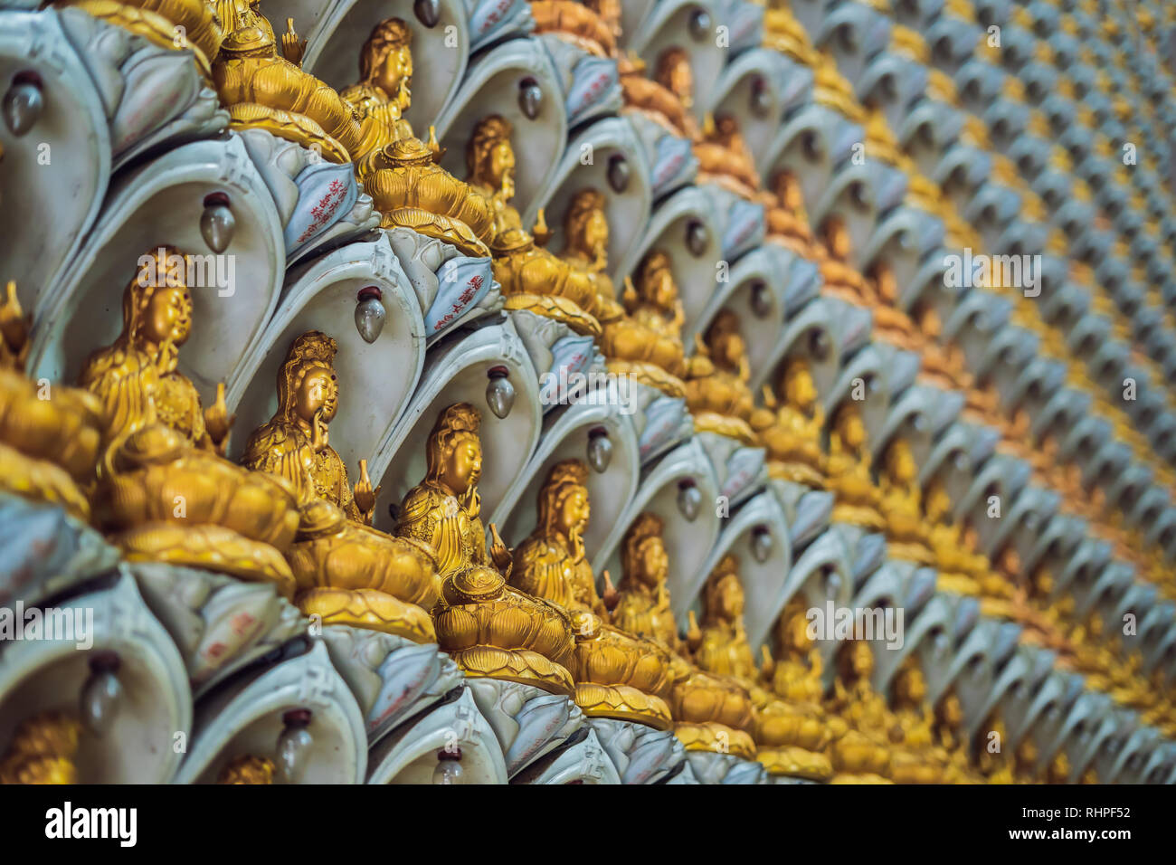 The wall in the temple is filled with buddhas. Religion Buddhism ...