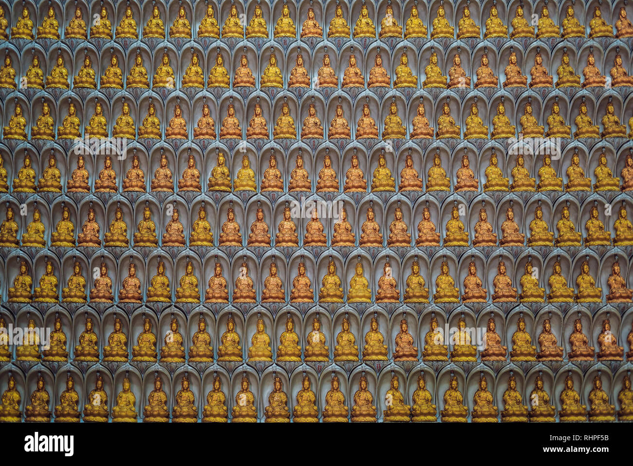 The wall in the temple is filled with buddhas. Religion Buddhism ...