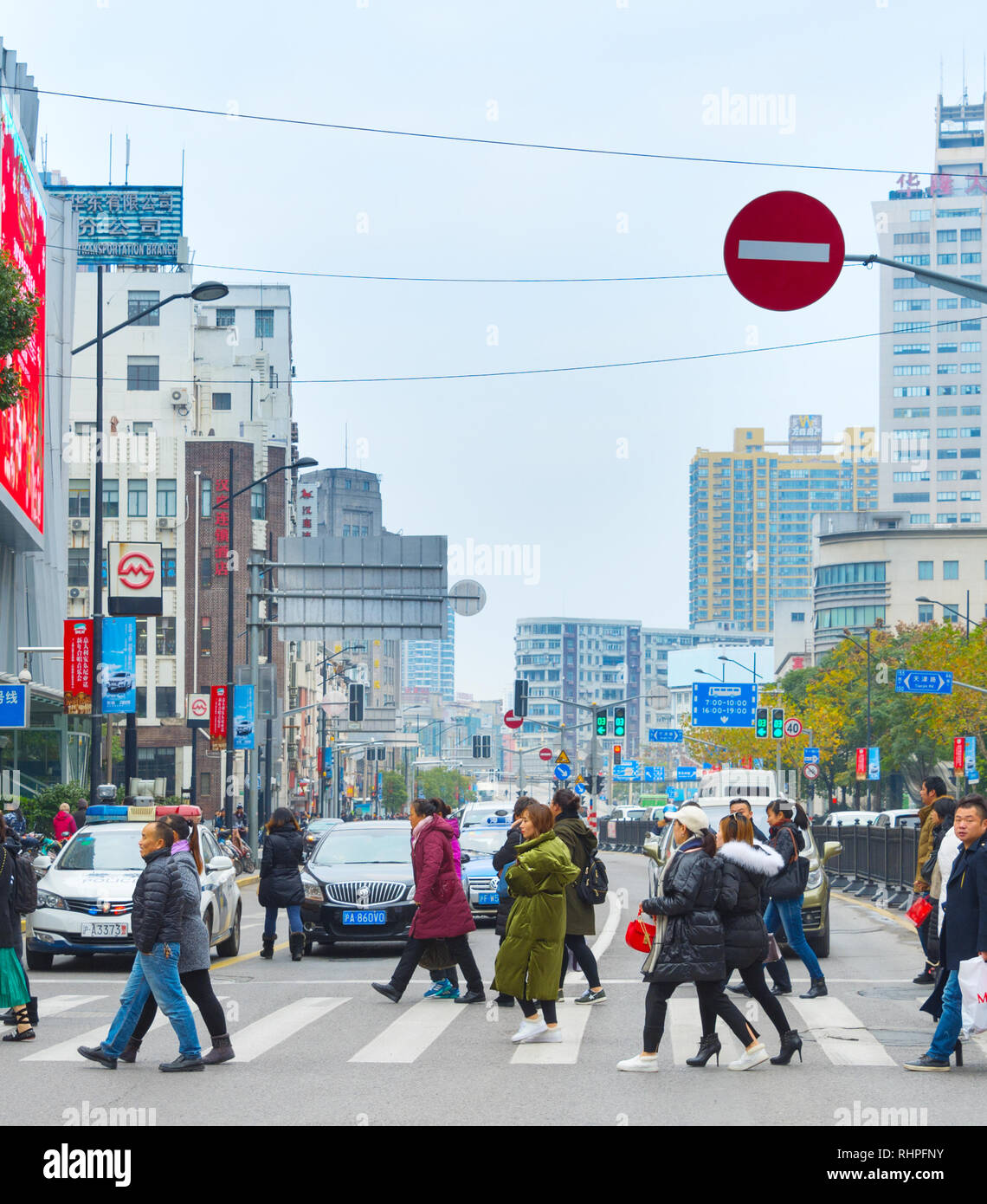 Crowd of people walking at crosswalk on the Shanghai city street, China ...