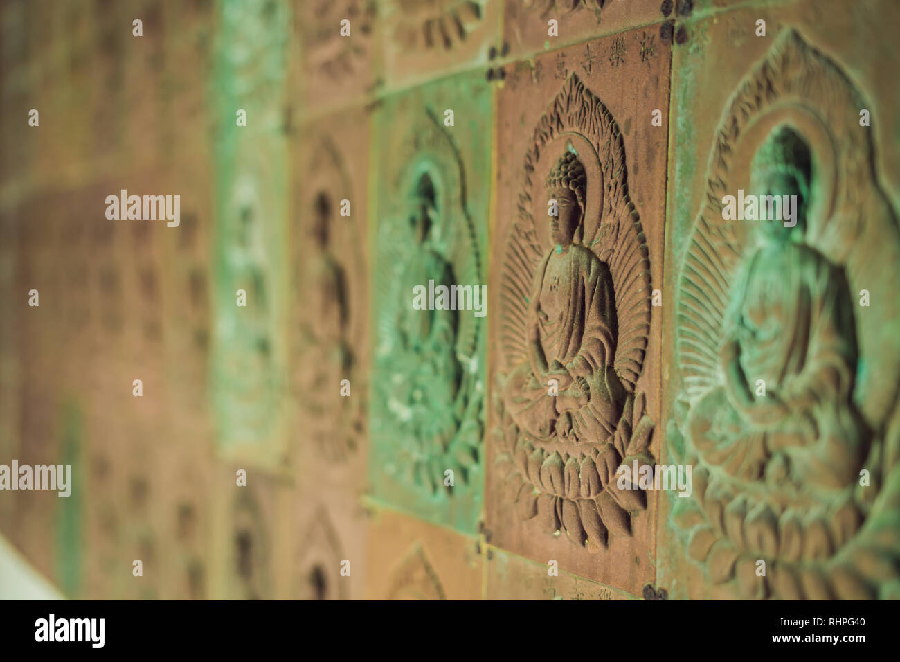 The wall in the temple is filled with buddhas. Religion Buddhism ...