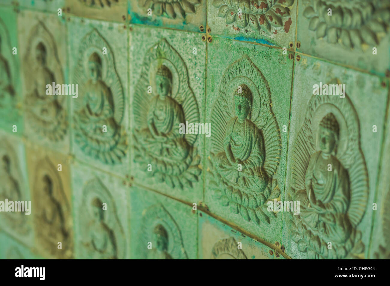 The wall in the temple is filled with buddhas. Religion Buddhism ...
