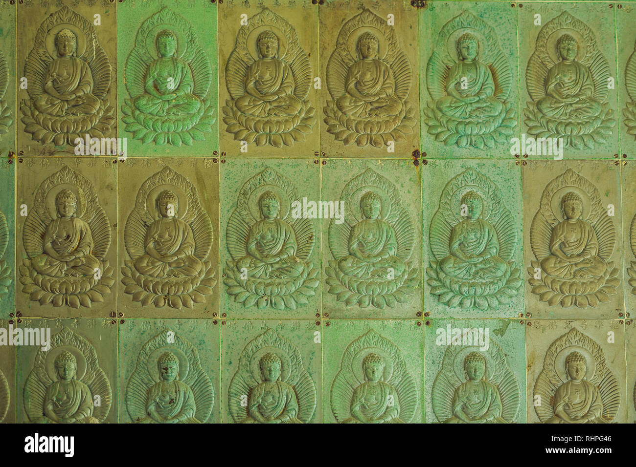 The wall in the temple is filled with buddhas. Religion Buddhism ...