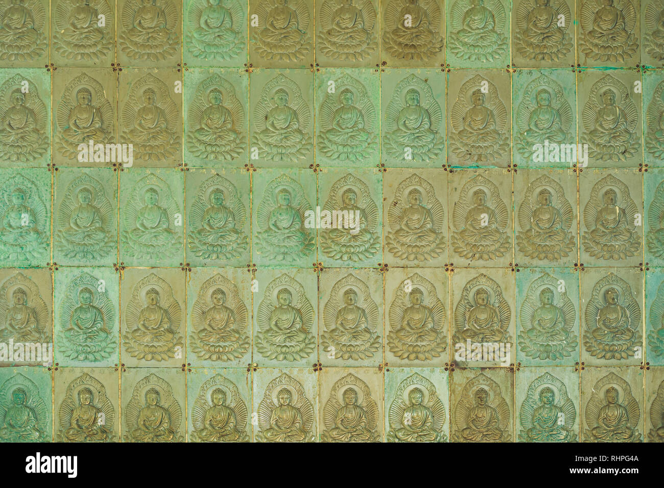 The wall in the temple is filled with buddhas. Religion Buddhism ...