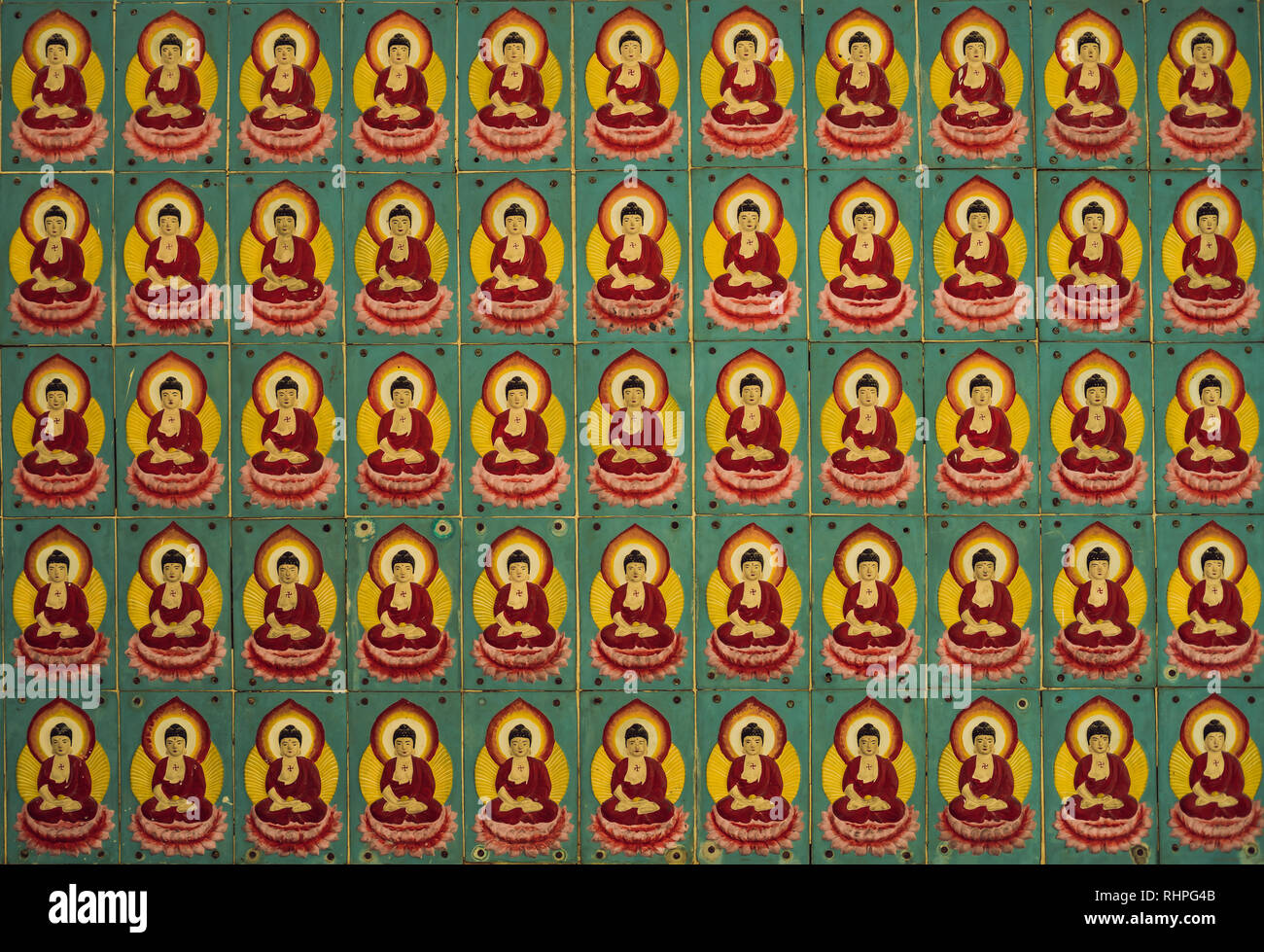The wall in the temple is filled with buddhas. Religion Buddhism ...