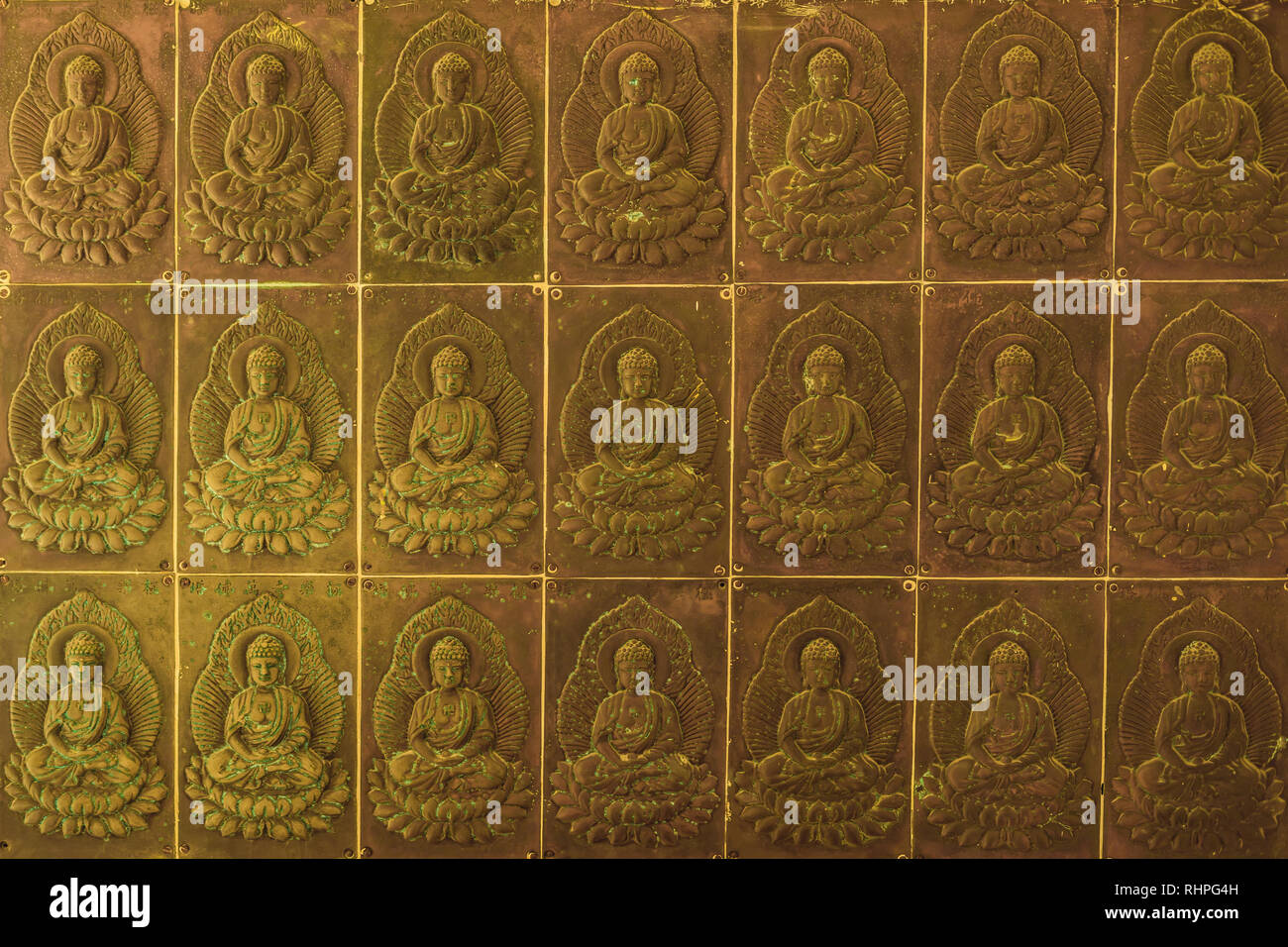 The wall in the temple is filled with buddhas. Religion Buddhism ...