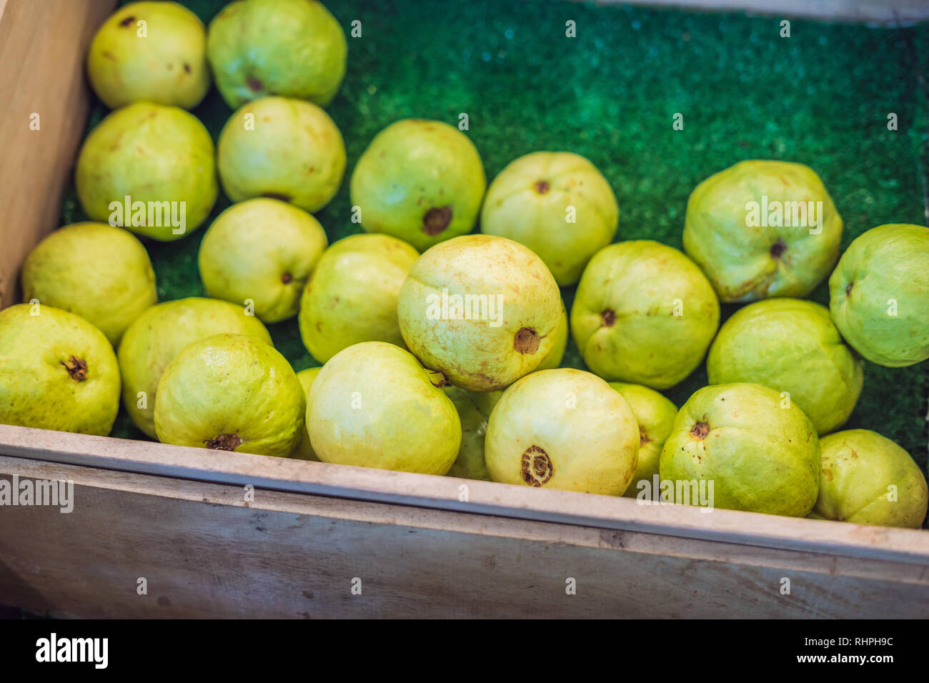 Green guava or pink guava stacking on the shop. Stacking of guava on ...