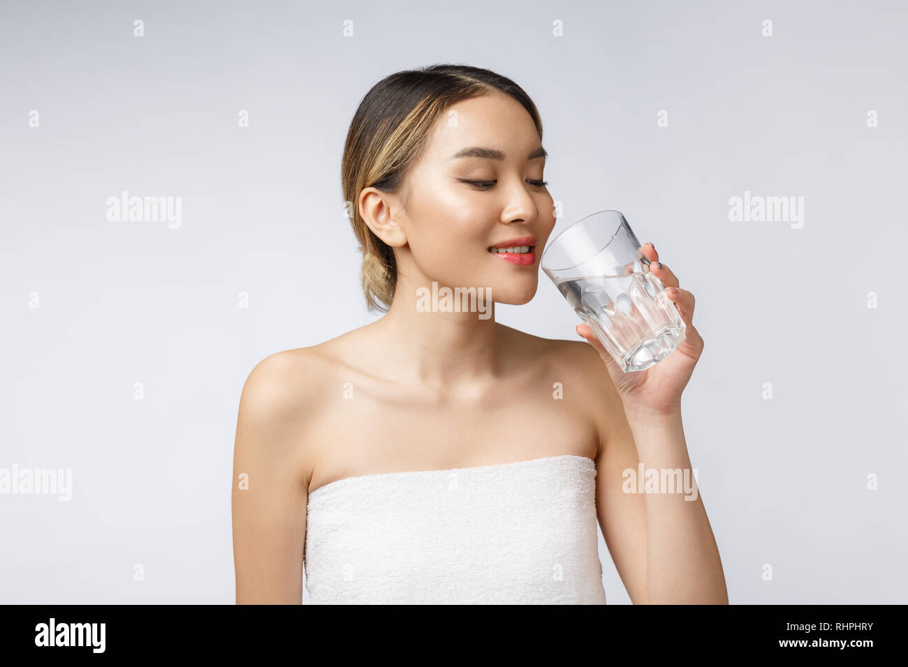 relaxed young smiling woman drinking clean water Stock Photo - Alamy