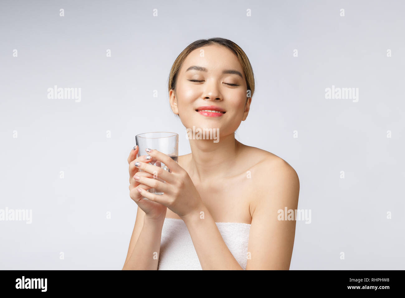 relaxed young smiling woman drinking clean water Stock Photo - Alamy