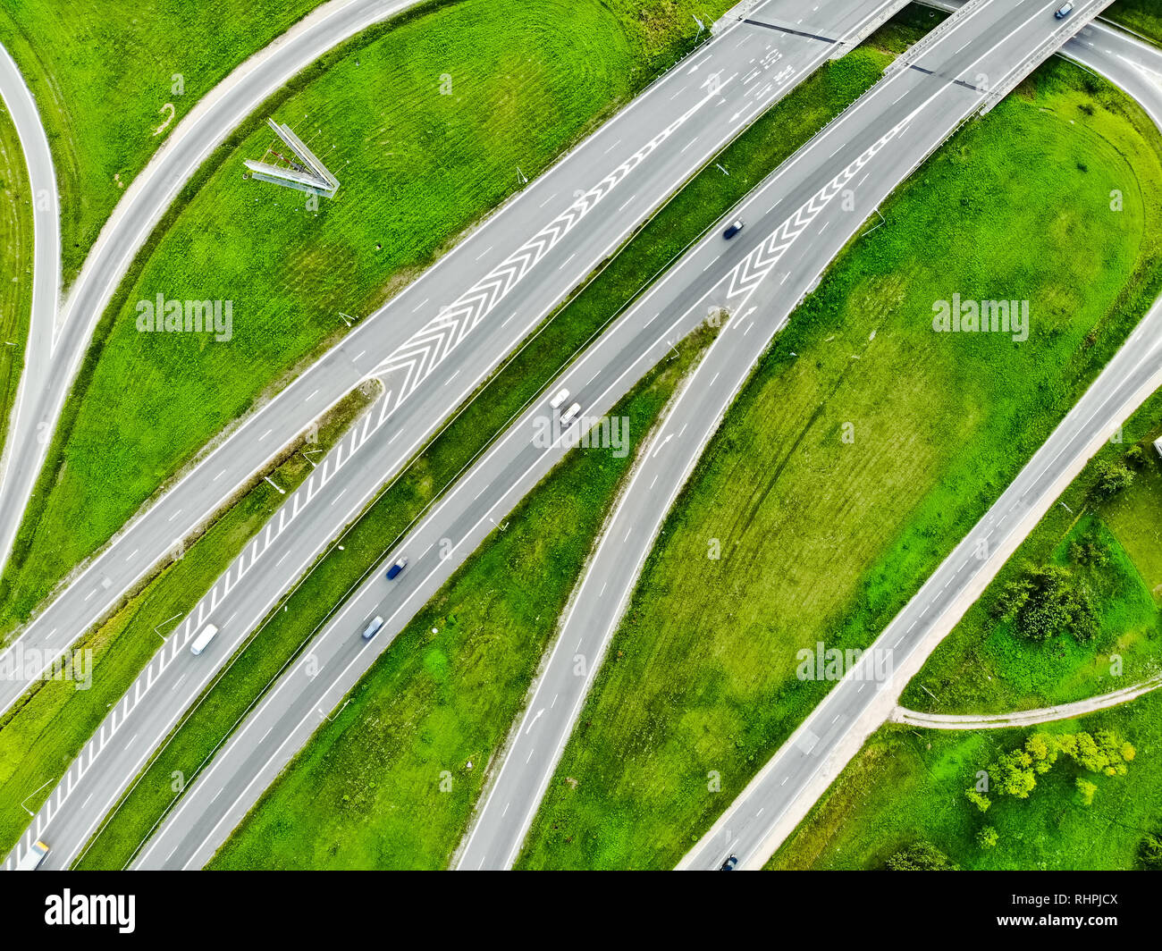 Aerial top down view of a highway road intersection. Cars passing ...
