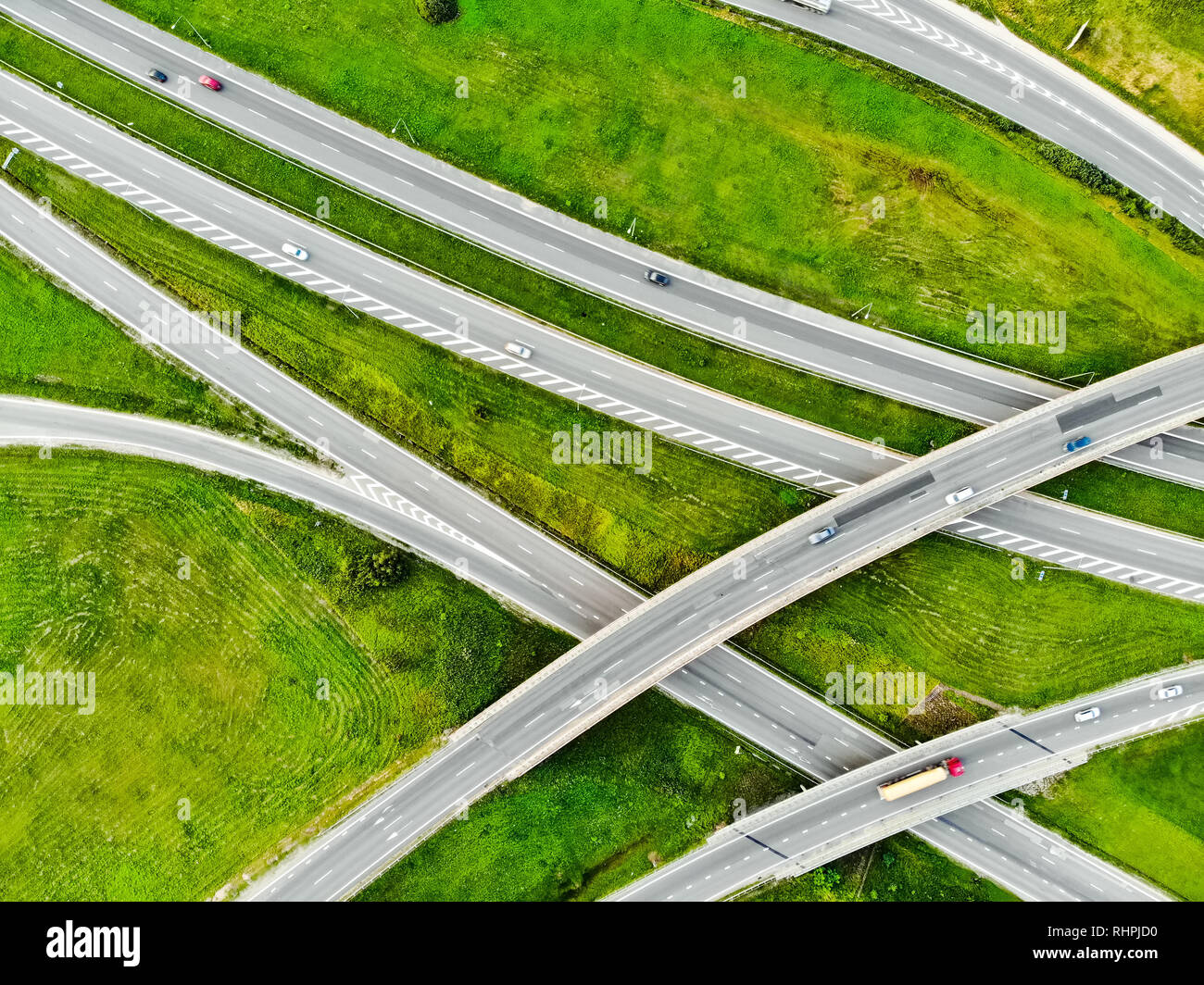 Aerial top down view of a highway road intersection. Cars passing ...