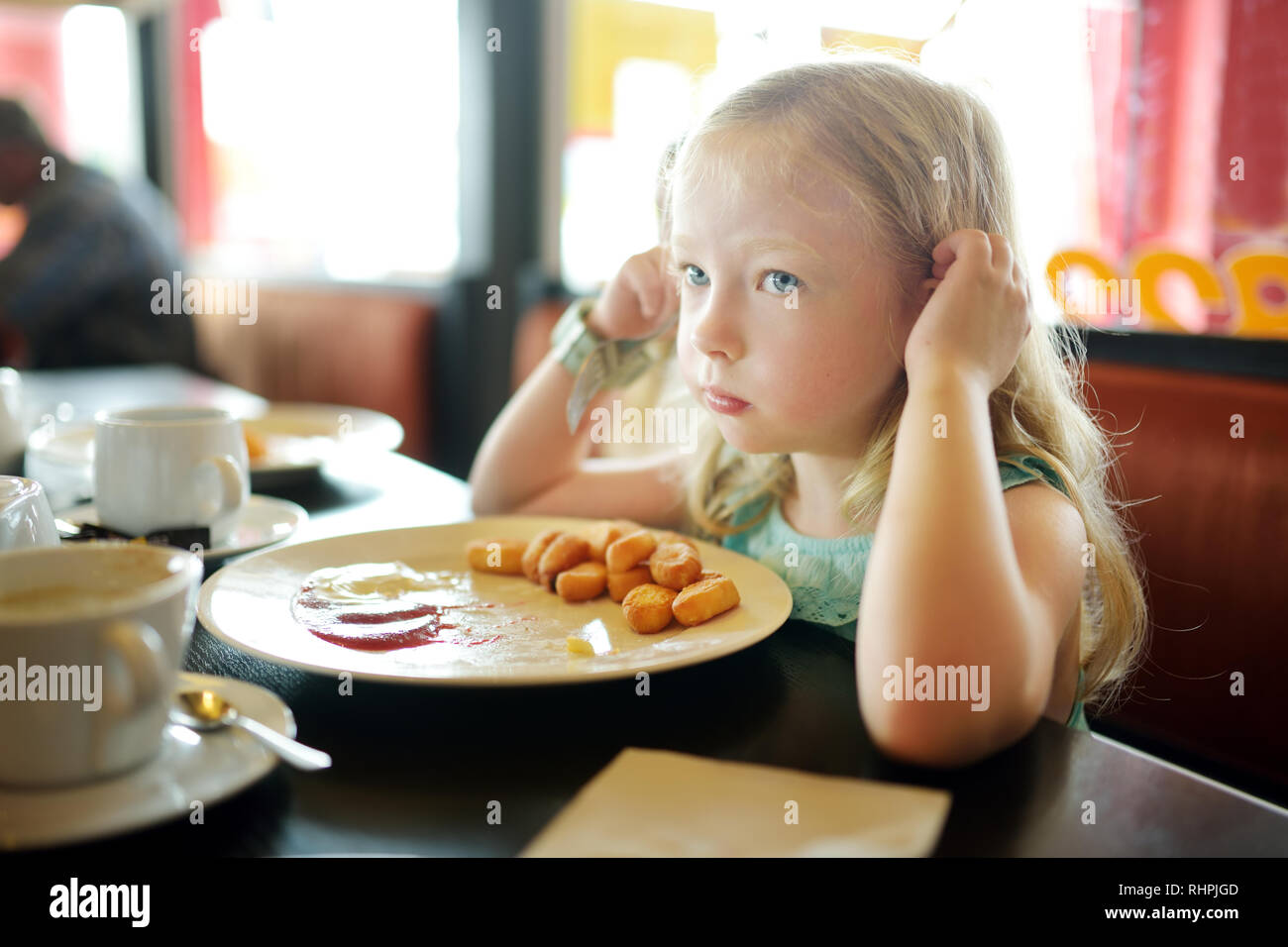 Cute girls eating curd dessert in a restaurant. Child having sweets ...