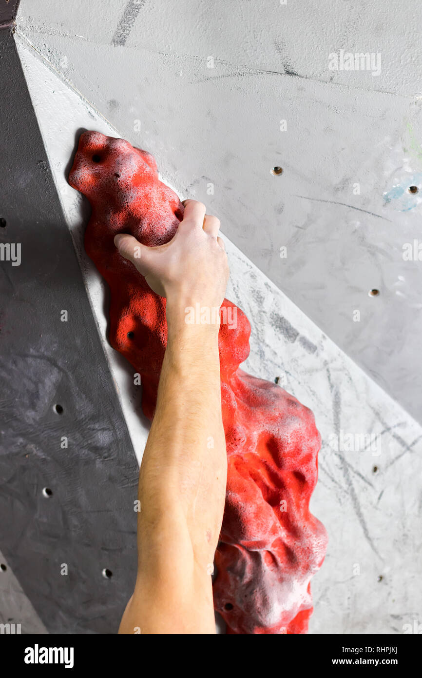 white man's hand is holding on the climbing wall Stock Photo - Alamy