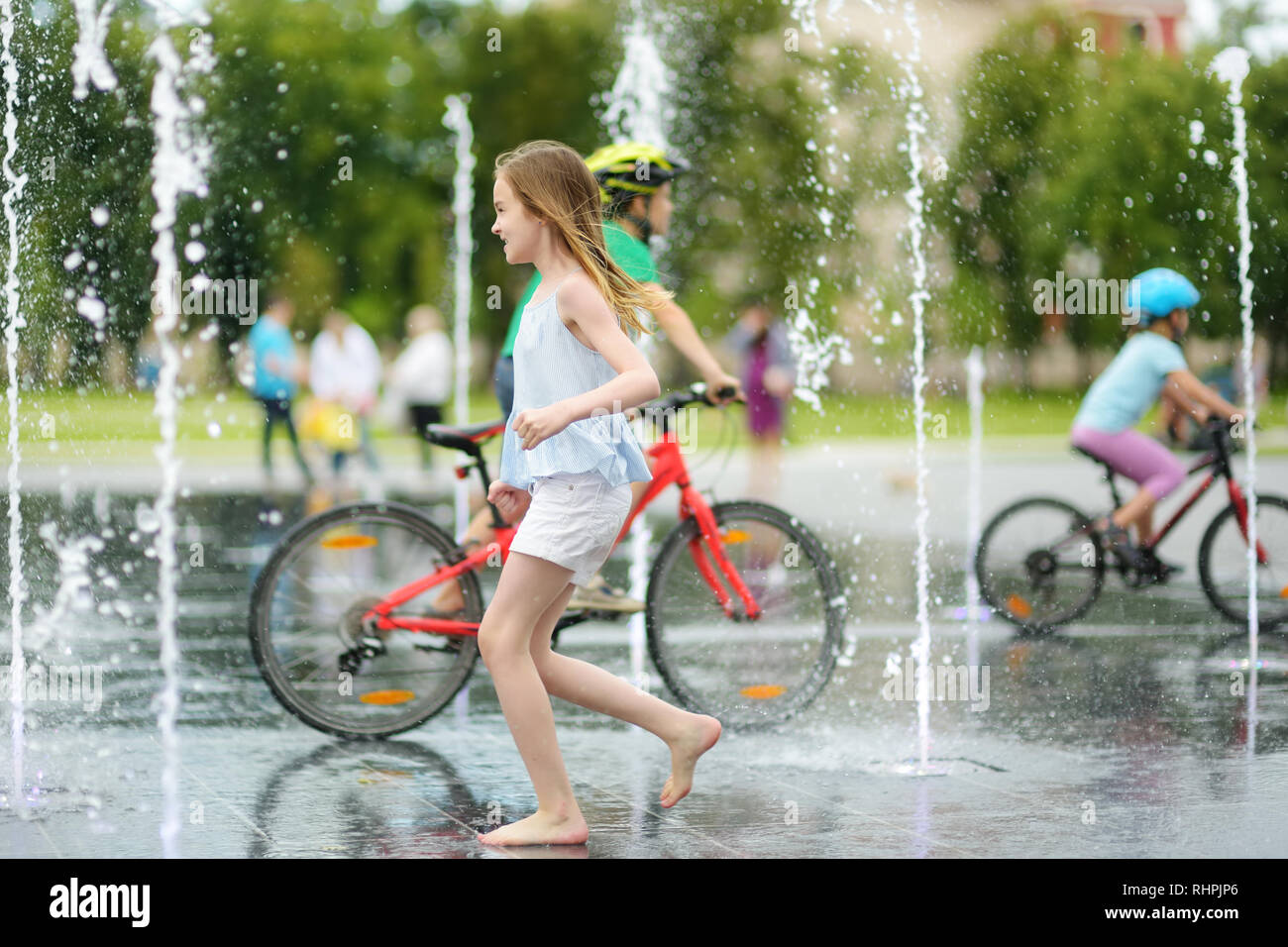Cute preteen girl playing in fountains on newly renovated Lukiskes ...