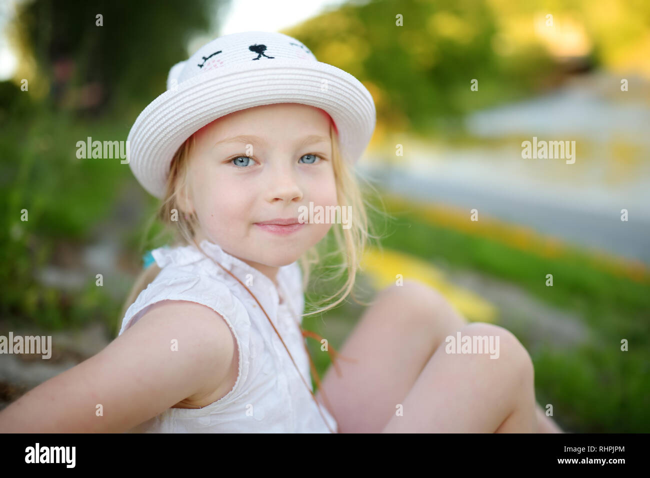 Cute little girl having fun outdoors on sunny summer evening. Child ...