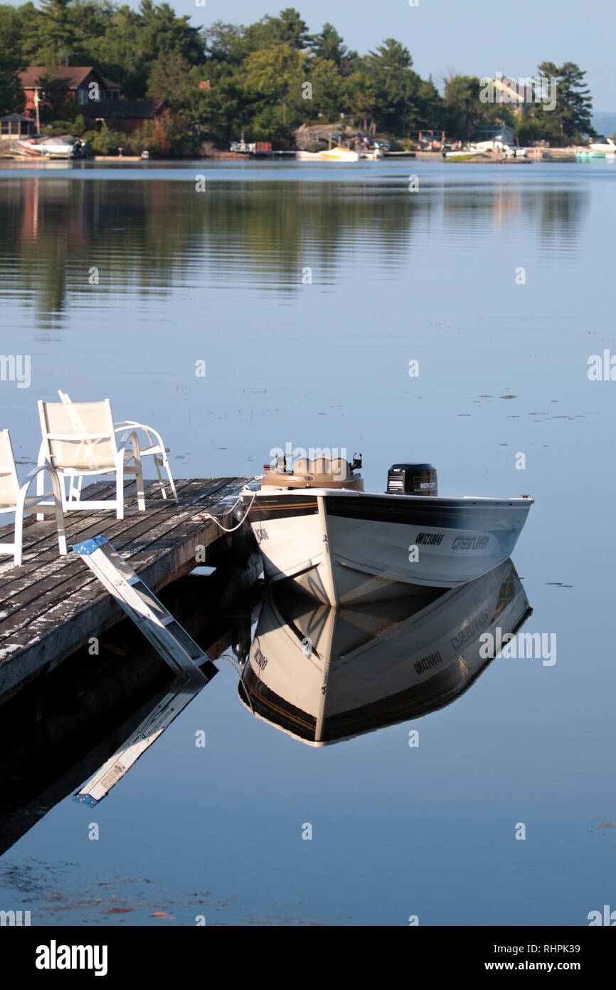Small outboard boat on Rice Lake Stock Photo - Alamy