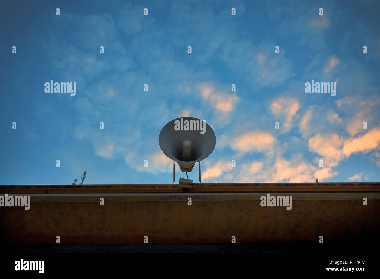loudspeaker on building roof against beautiful morning colorful sky ...