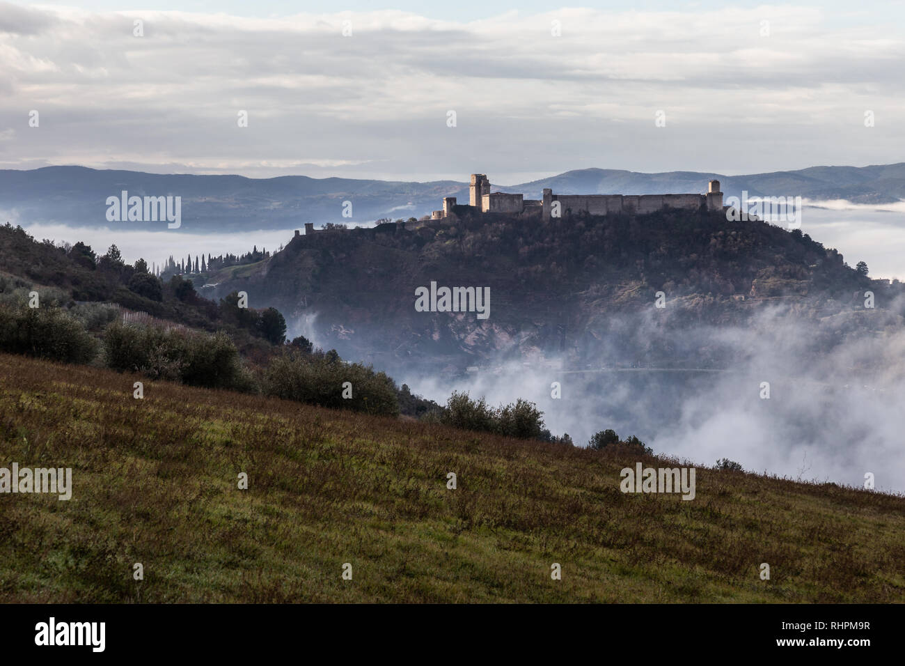 A view of Rocca Maggiore castle in Assisi (Umbria, Italy) in the middle ...