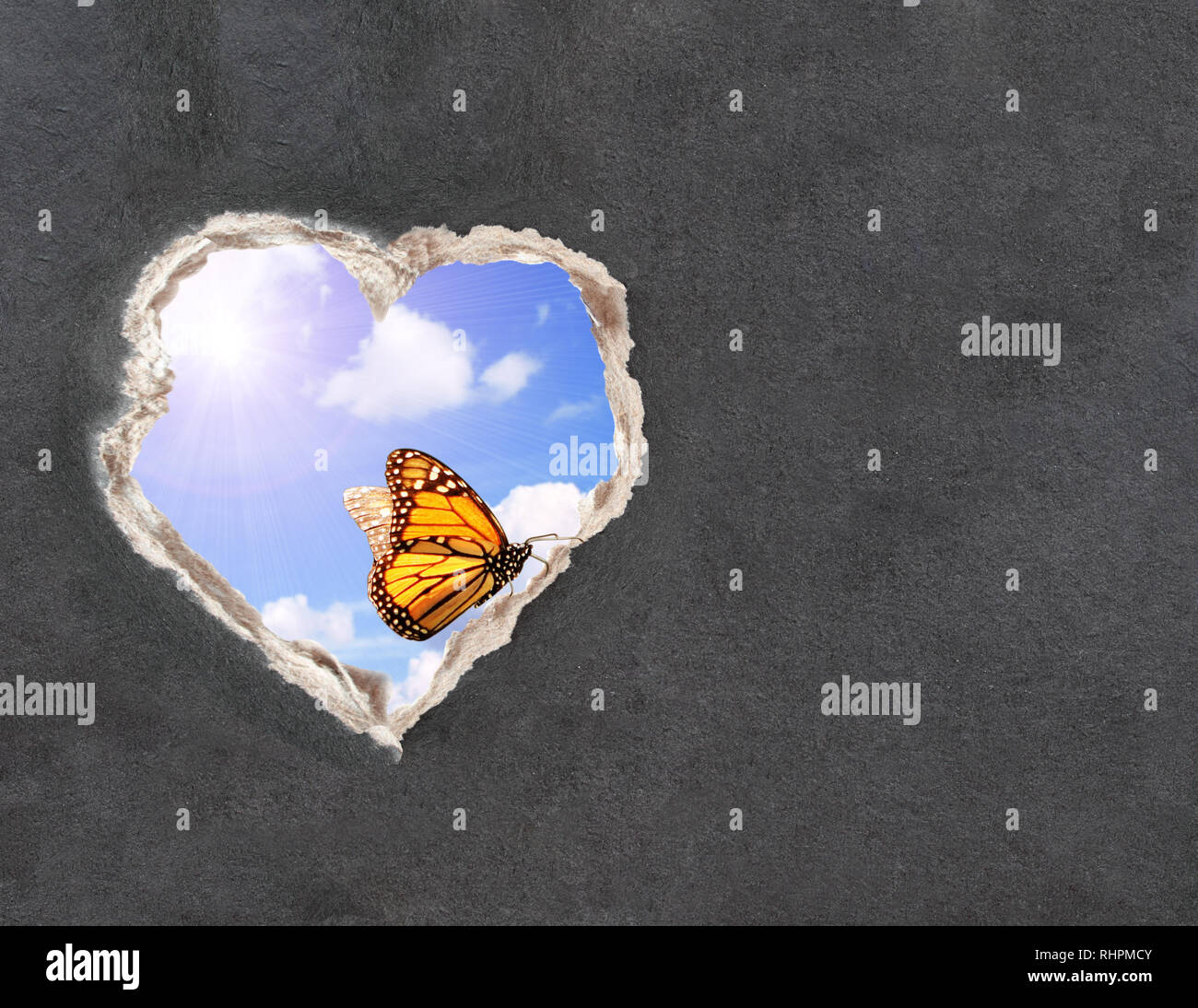 Eco concept. Blue sky, bright sun and butterfly in a hole paper in the ...