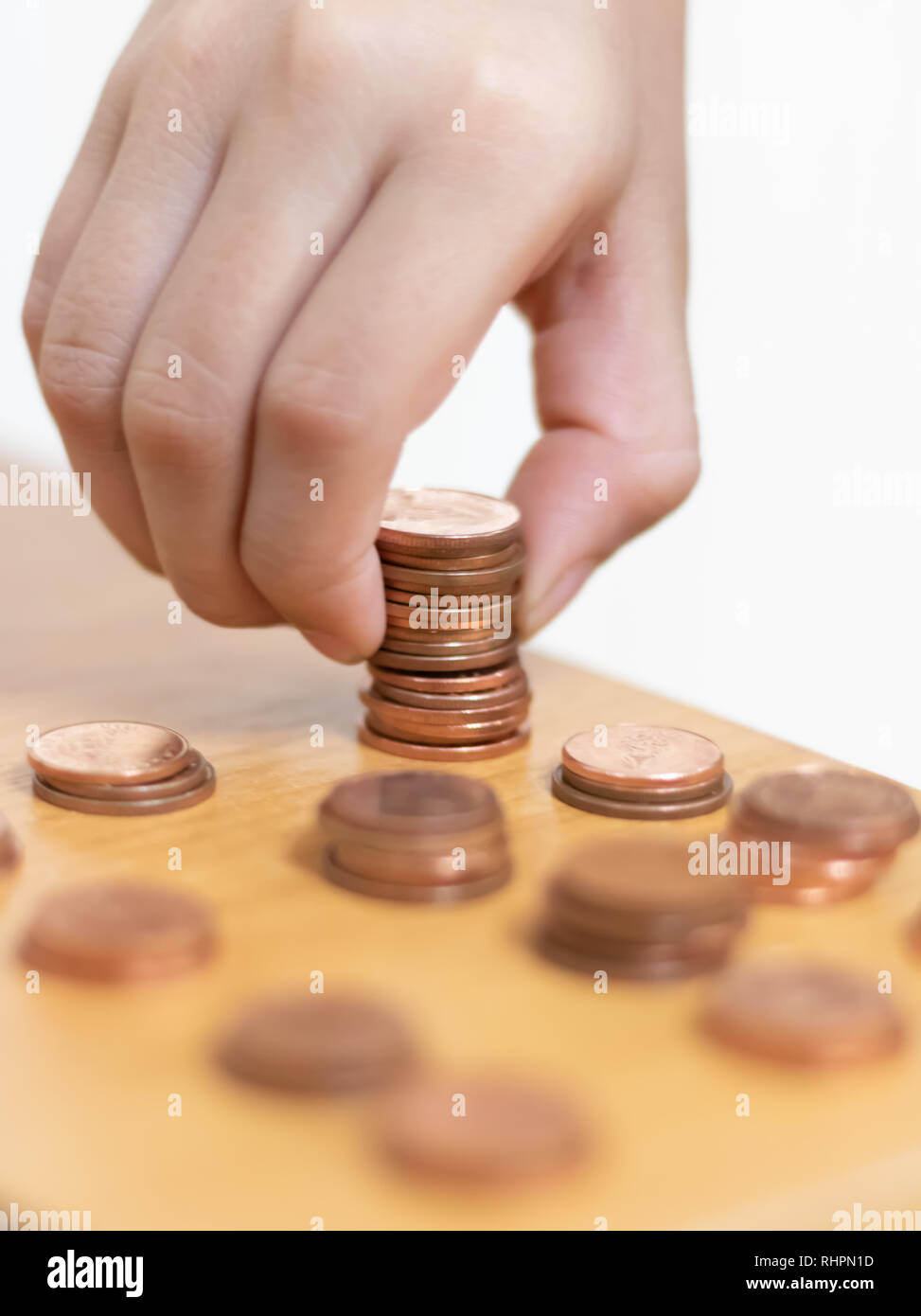 Hand and coin stacking Stock Photo - Alamy