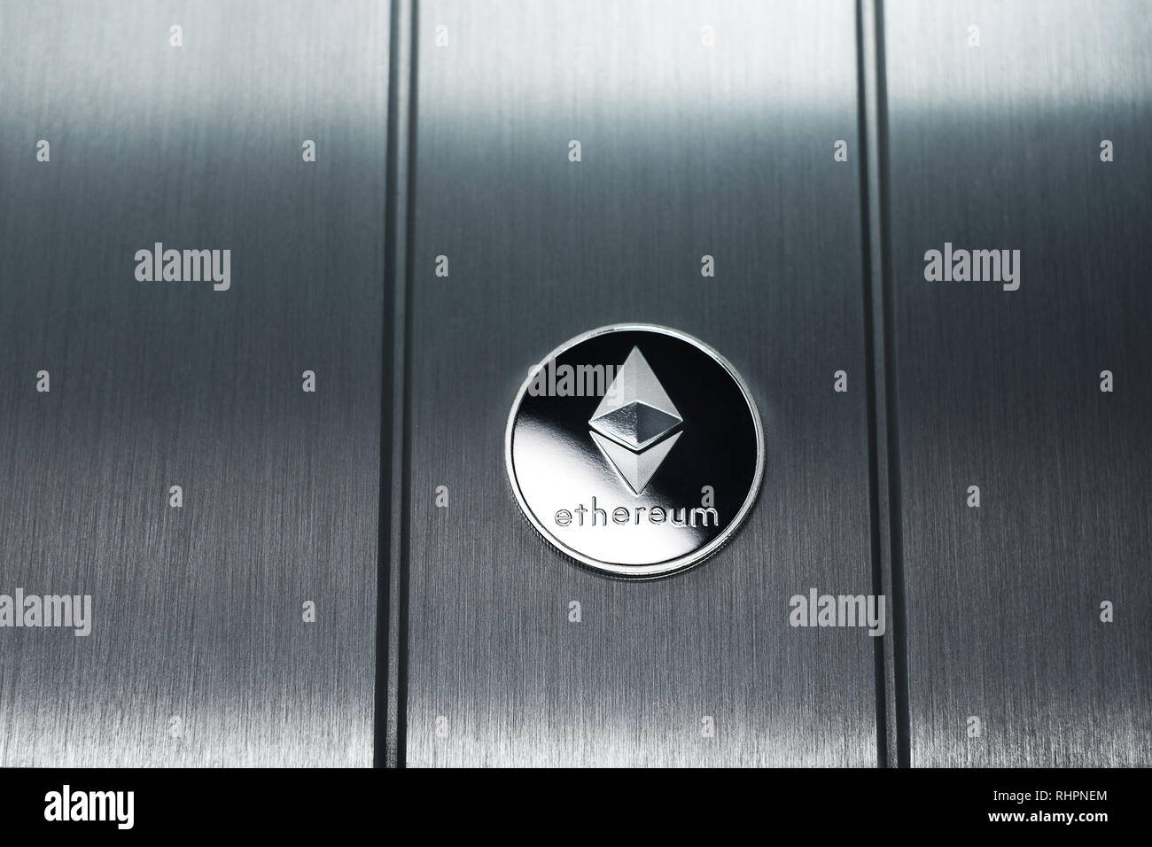 Ethereum Silver coin lies on the metallic shiny surface Stock Photo - Alamy