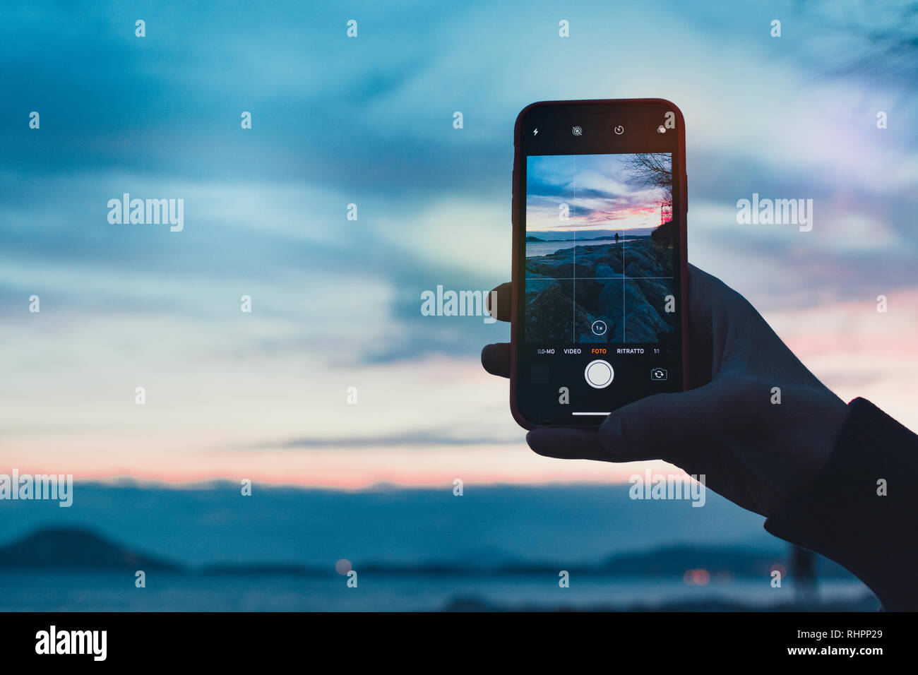 hand holding smart phone with landscape background with copy space ...