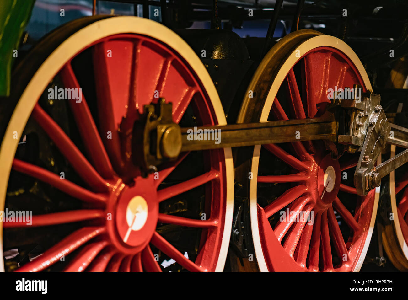 Bright red wheels of old locomotive on railway tracks closeup. Absract ...