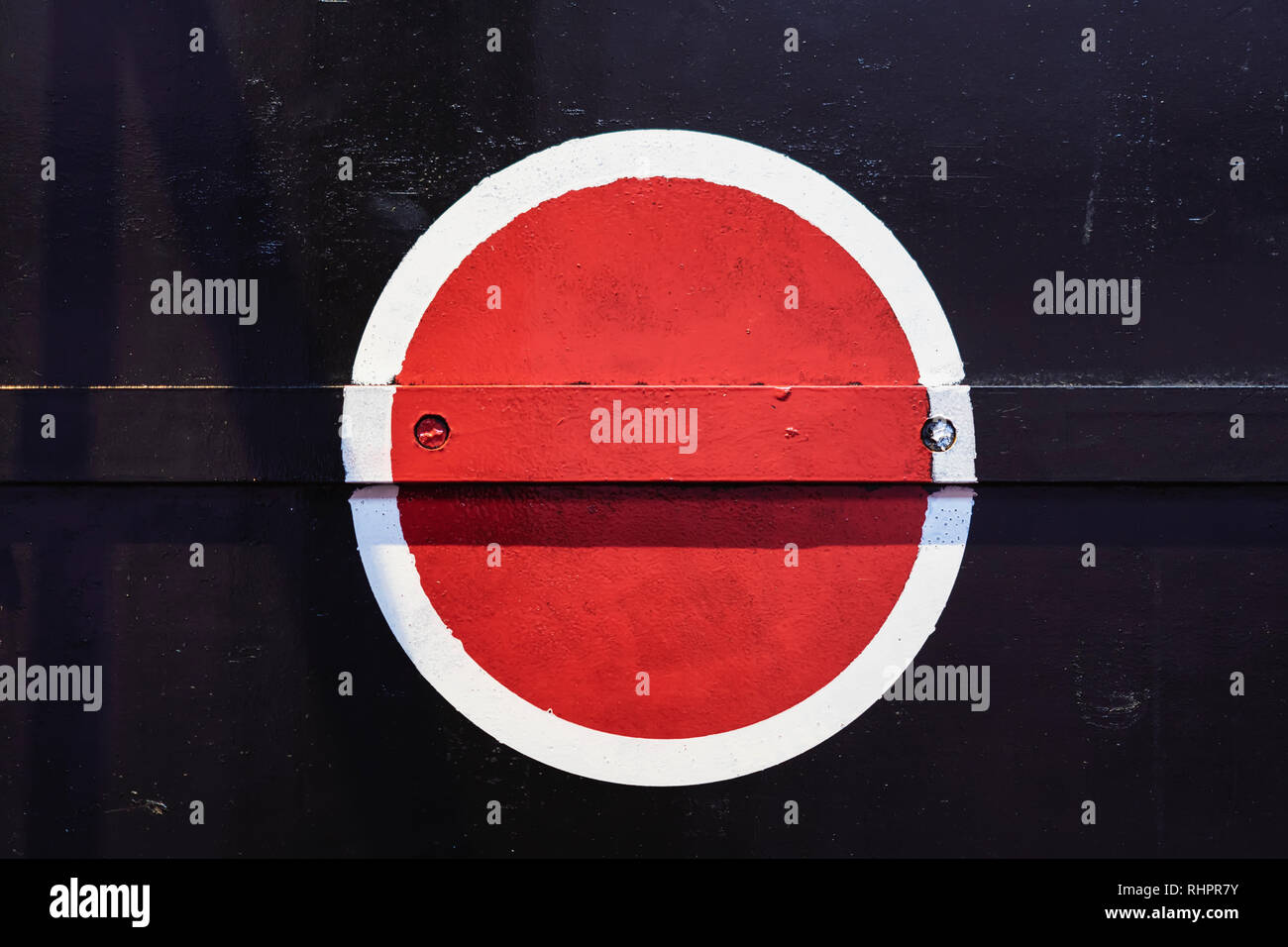 Drawn painted red circle on a black metallic old surface, like graffiti ...