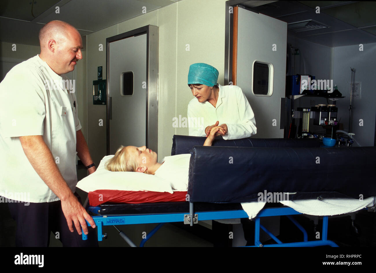young girl on stretcher being taken into operating theatre by ...
