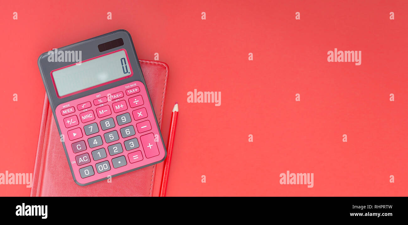 red calculator and organizer on the red table with red pencil Stock ...