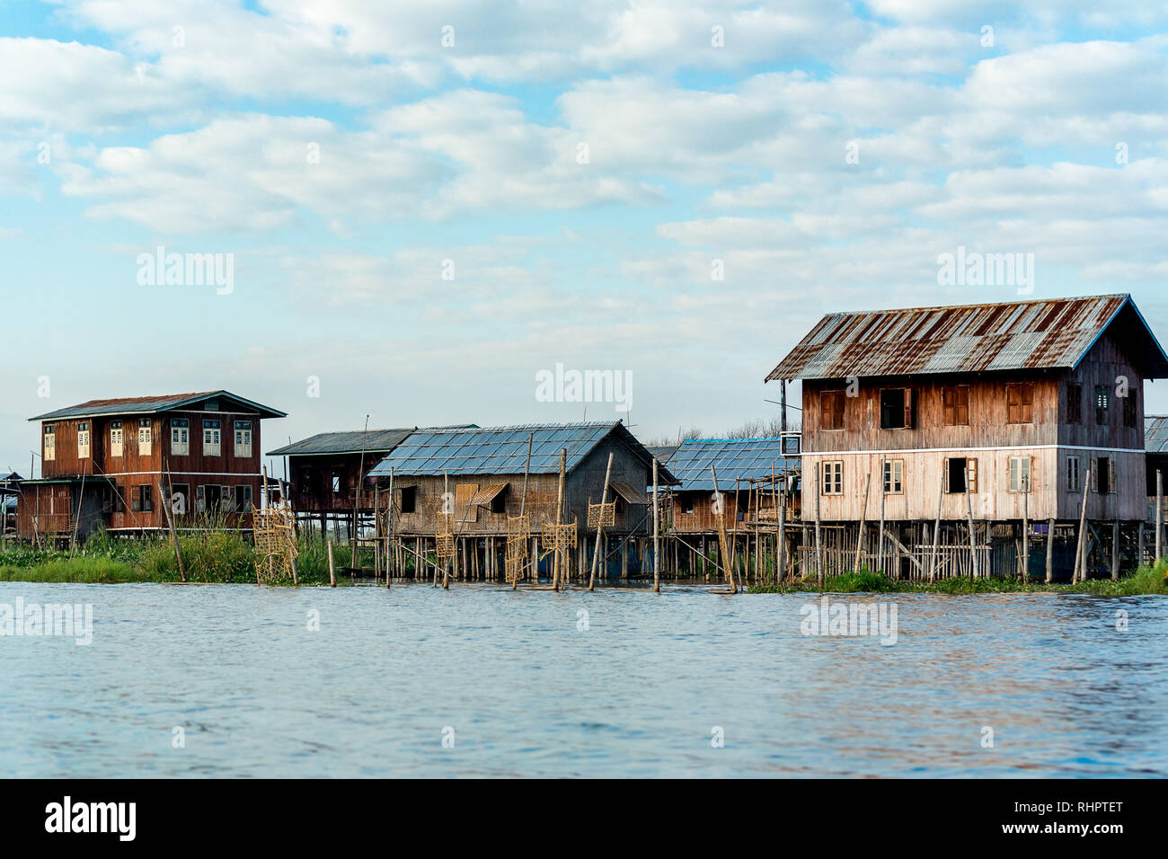 Traditional simple stilt houses and building of a village on Inle Lake ...