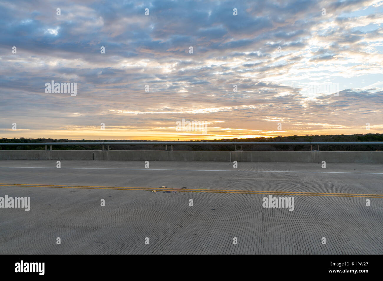 View of Sunrise From a 2 way Bridge With Double yellow lines Stock ...