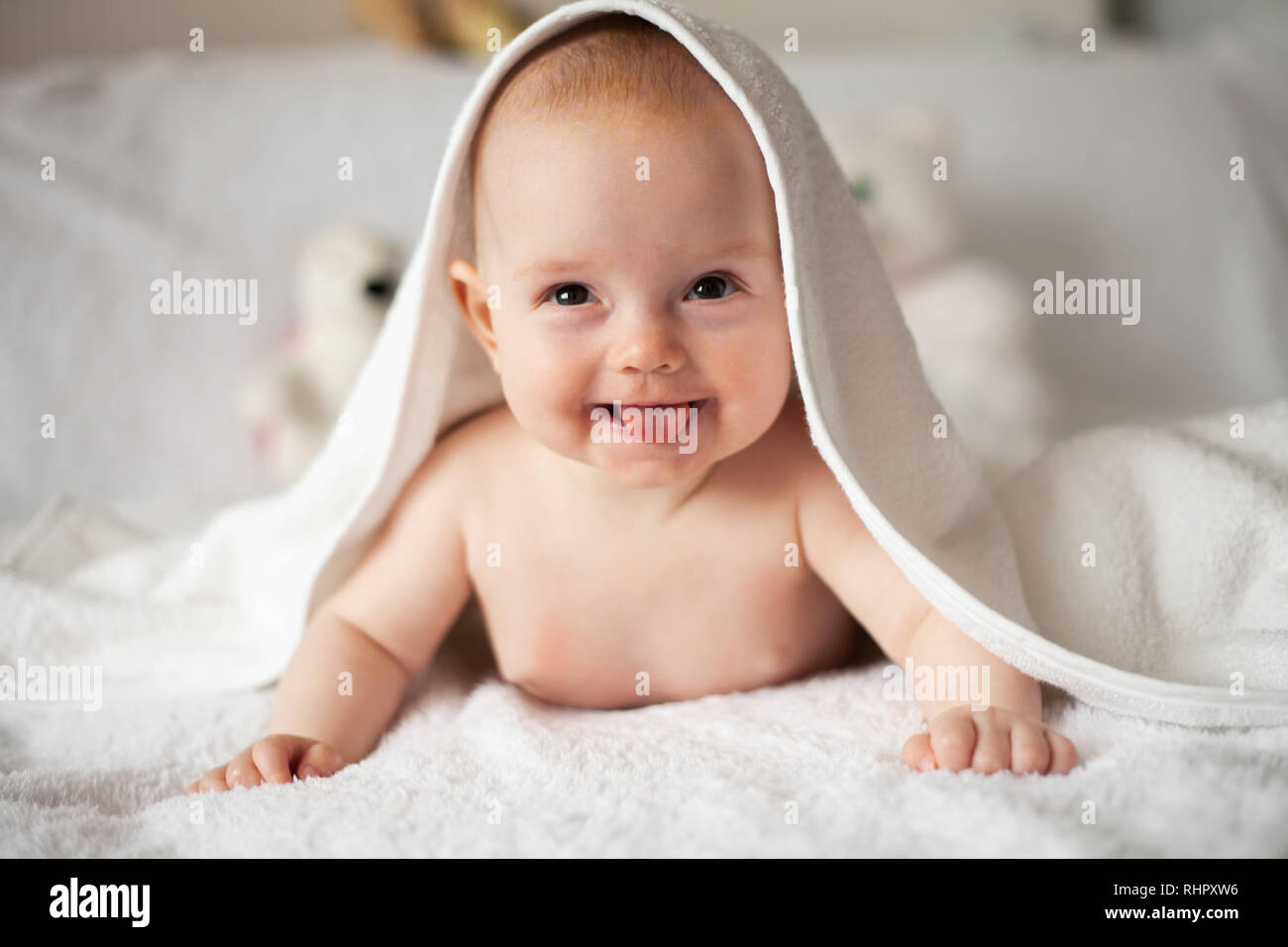 baby girl is hiding under the white blanket Stock Photo - Alamy