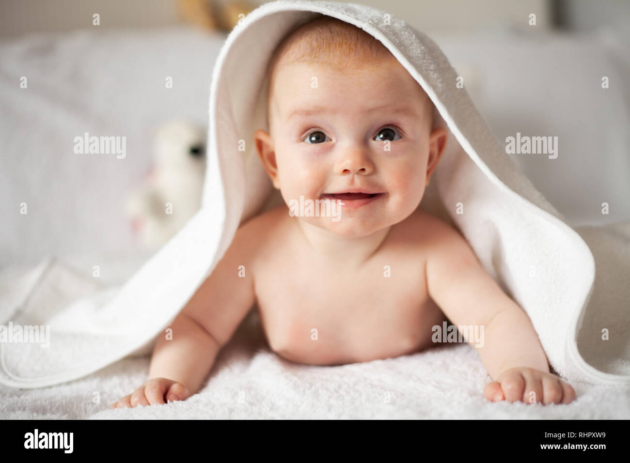 baby girl is hiding under the white blanket Stock Photo - Alamy