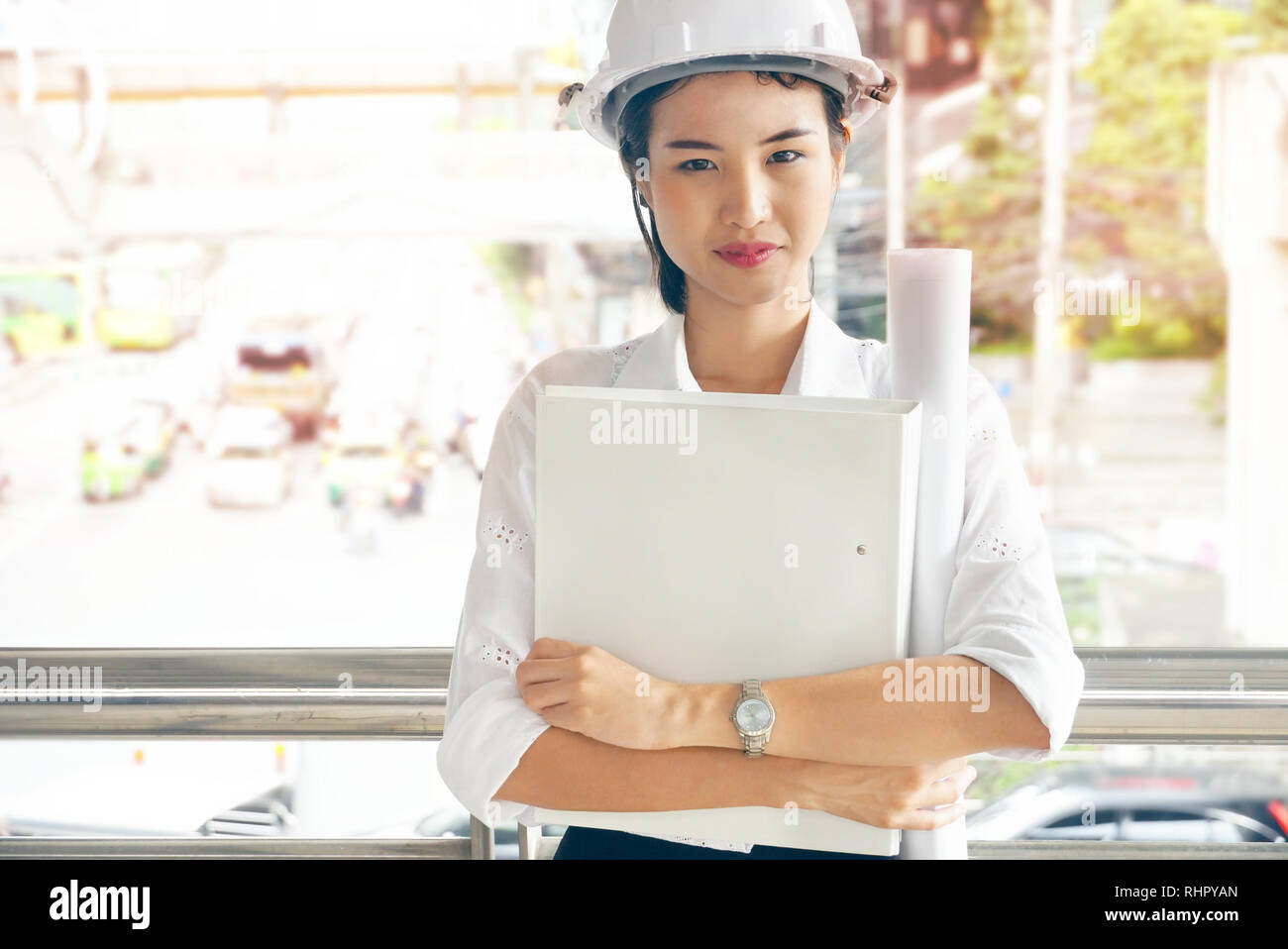 Engineer woman wear helmet safety and design paper stand at site ...