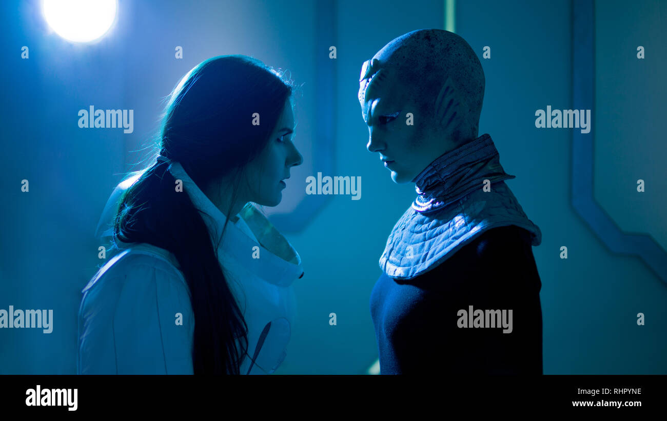 Woman and an alien look at each other. Contact with other civilizations ...