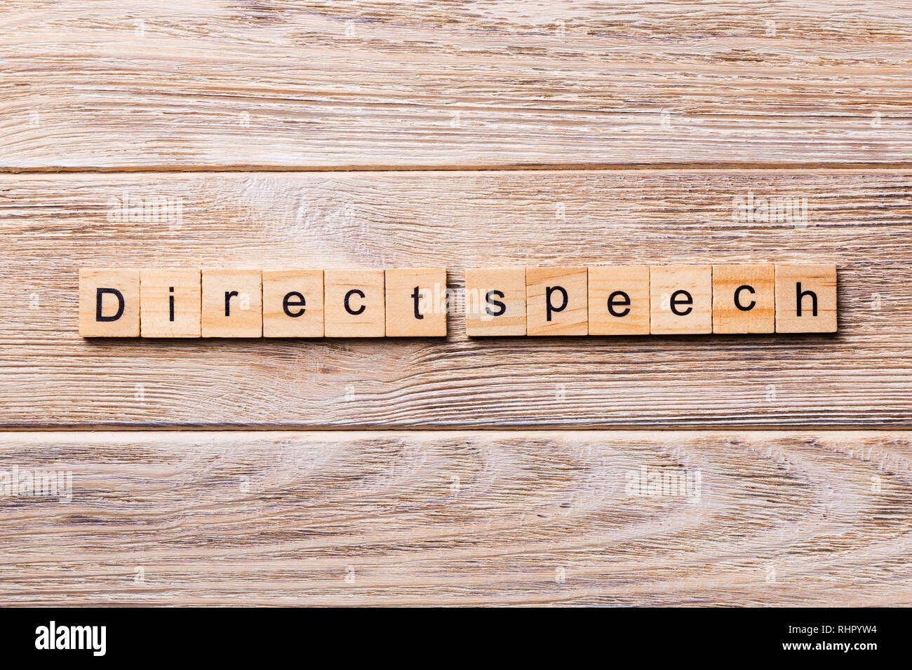 direct speech word written on wood block. direct speech text on wooden ...