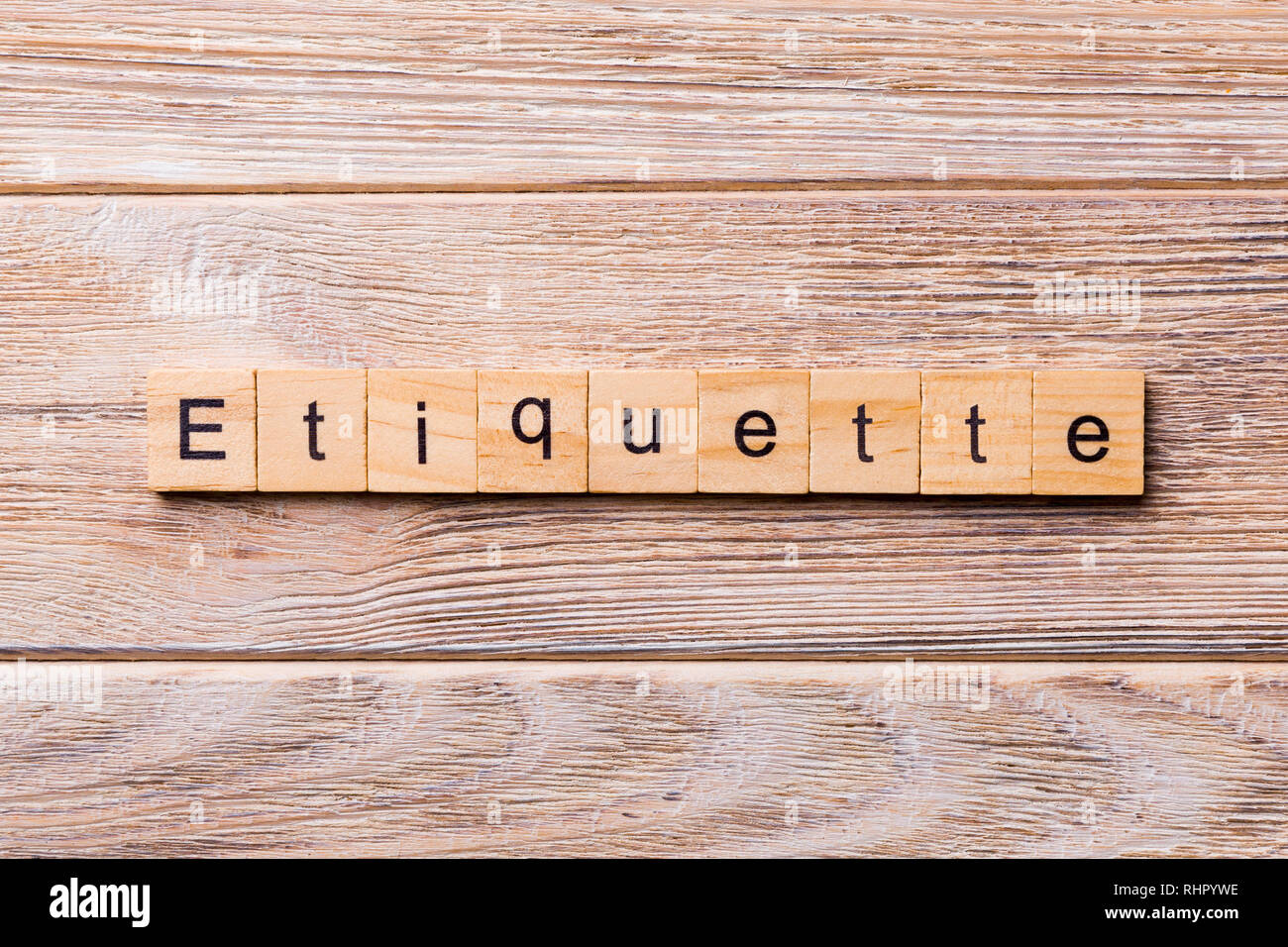 ETIQUETTE word written on wood block. ETIQUETTE text on wooden table ...
