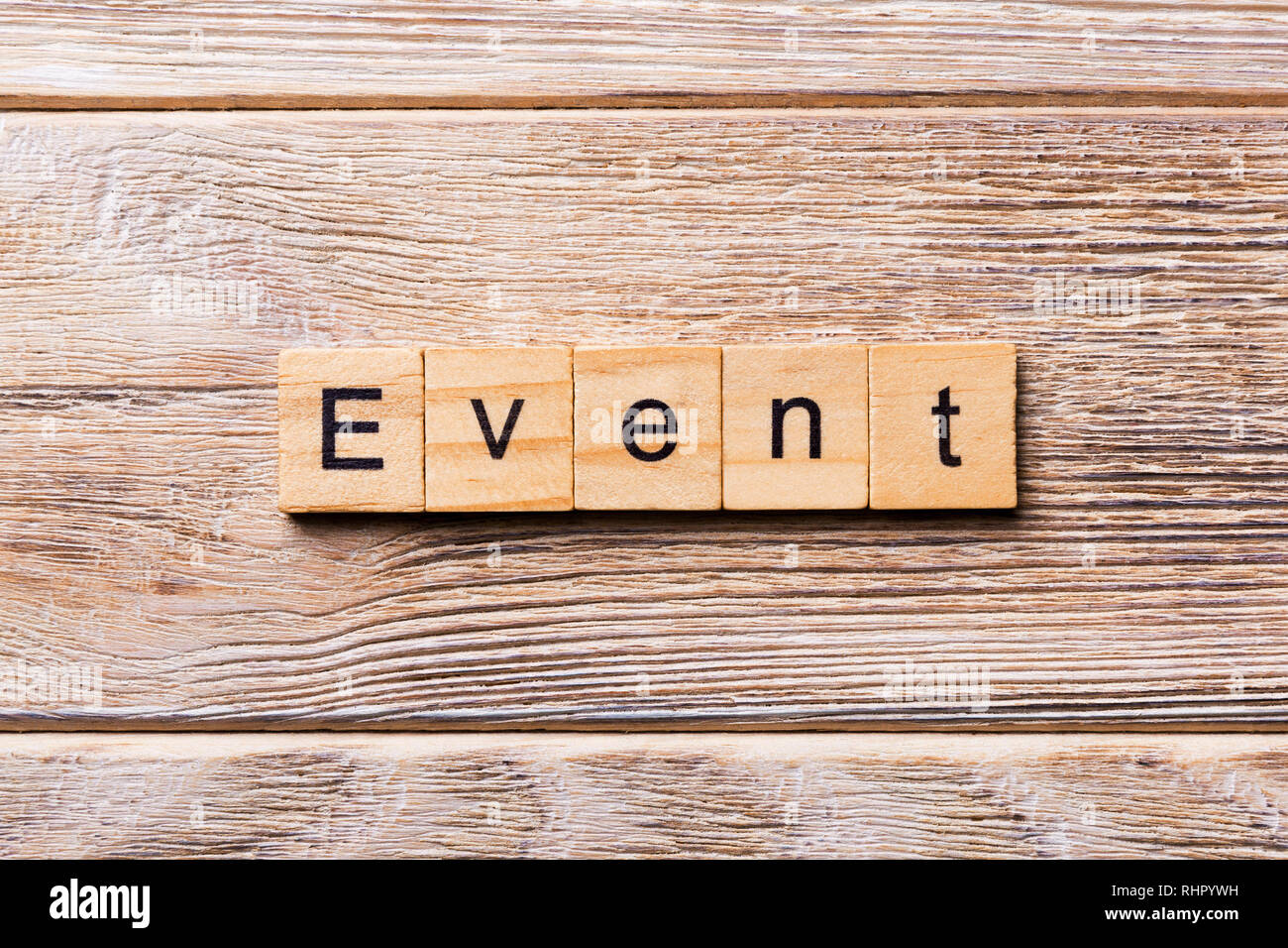 Event word written on wood block. Event text on wooden table for your ...