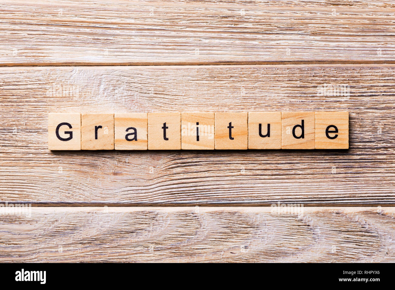 gratitude word written on wood block. gratitude text on wooden table ...