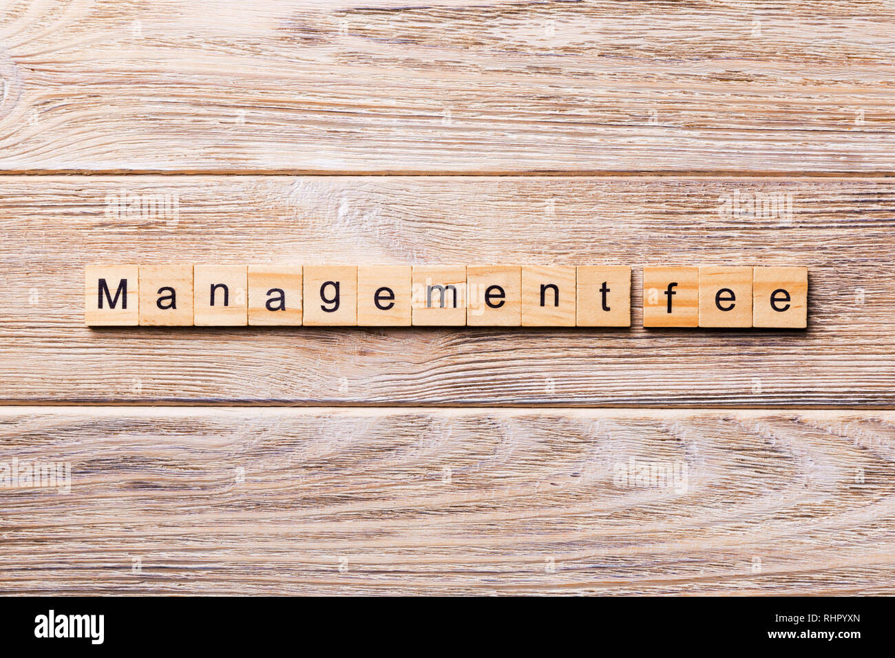 management fee word written on wood block. management fee text on ...
