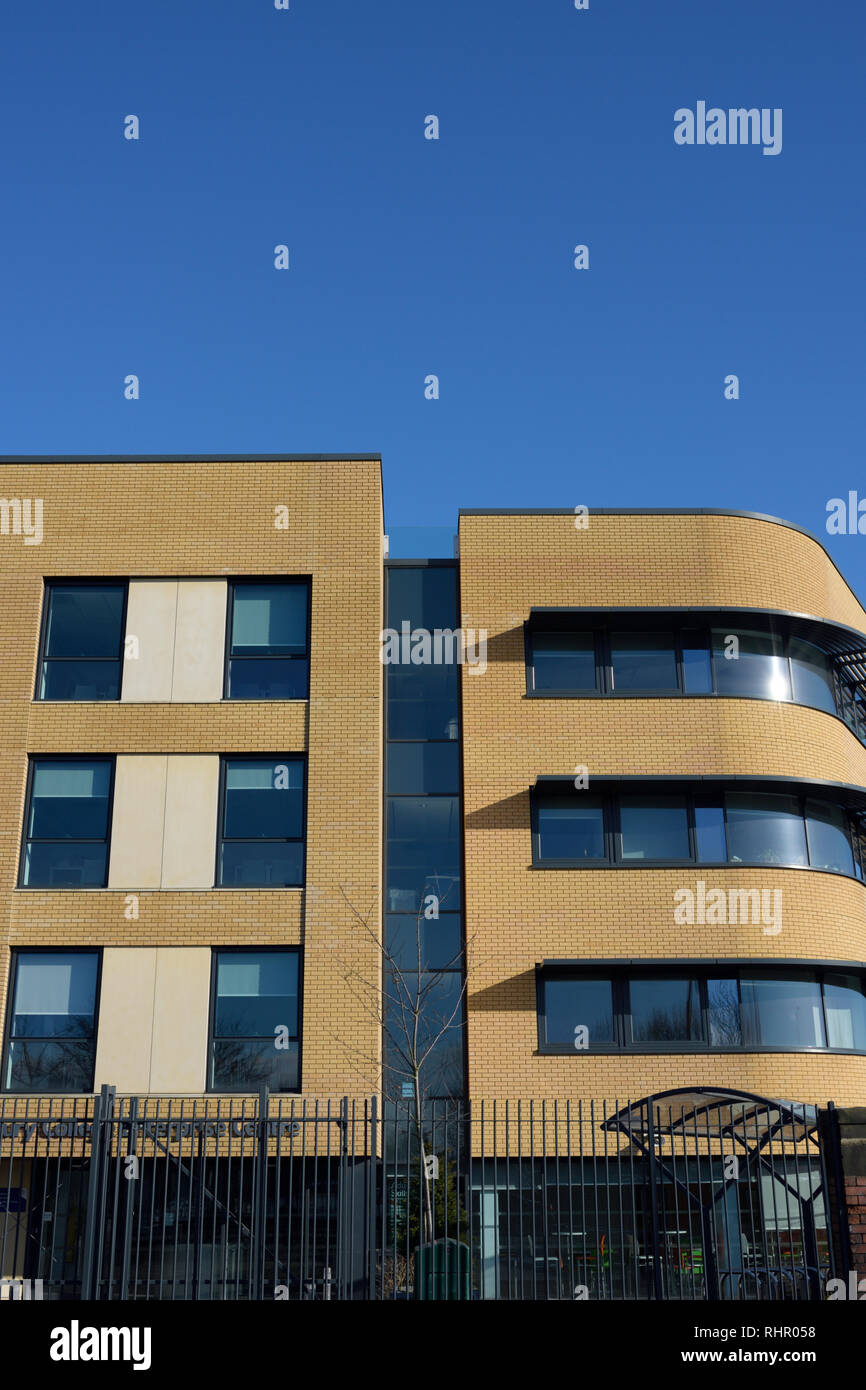 Modern building with curved facade, buff brickwork and curved ribbon ...